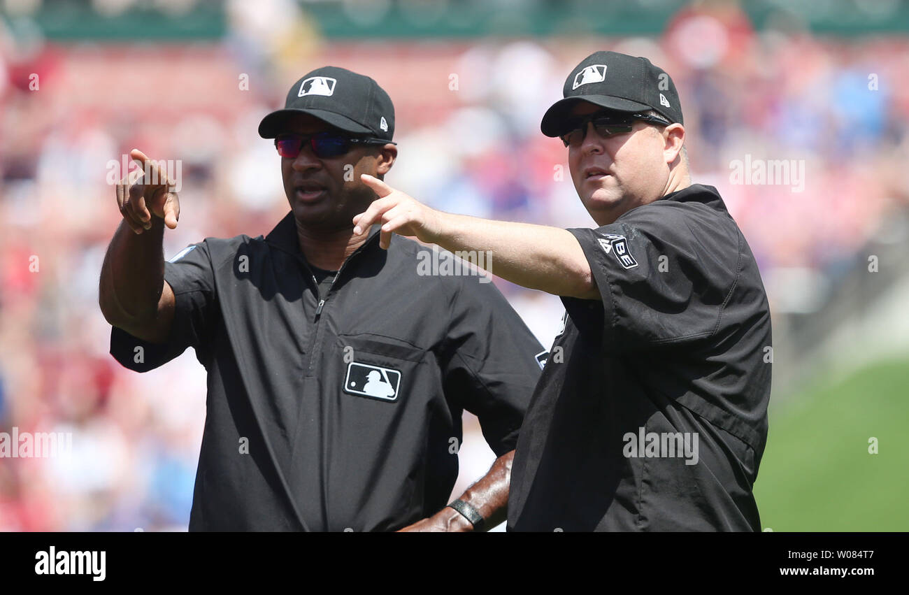 Umpires Alan Porter and Todd Tichenor (R) point to family members in ...