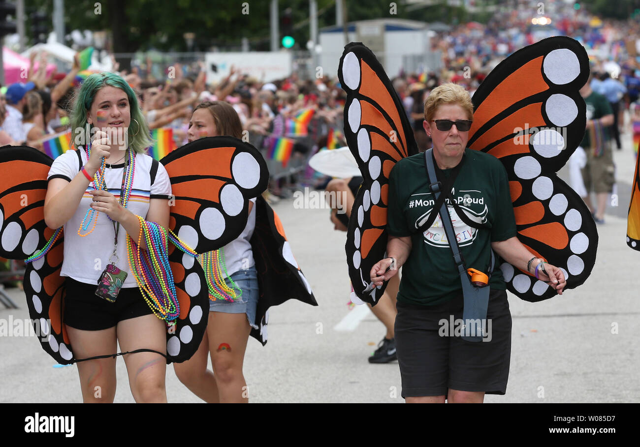 Parade goers wear butterfly wings as they march in the St. Louis ...