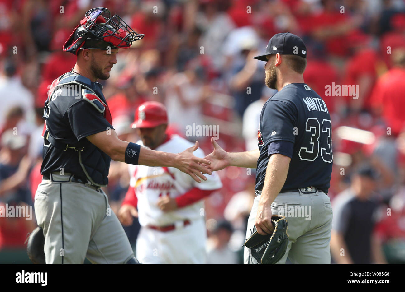 Atlanta Braves catcher Tyler Flowers congratulates pitcher A.J. Minter ...