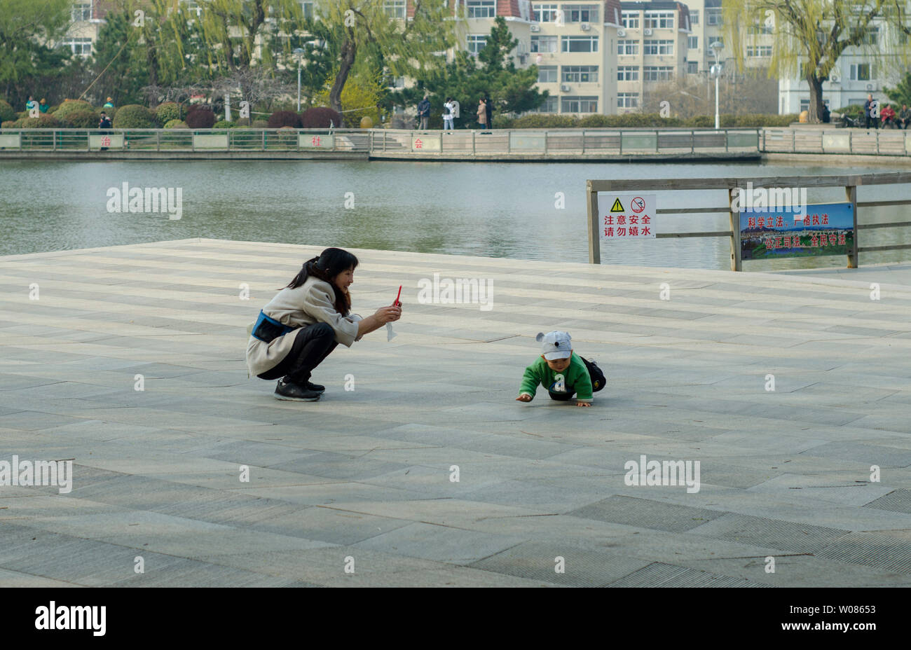 Lee Village Park riverside mother is taking pictures of her son who is ...