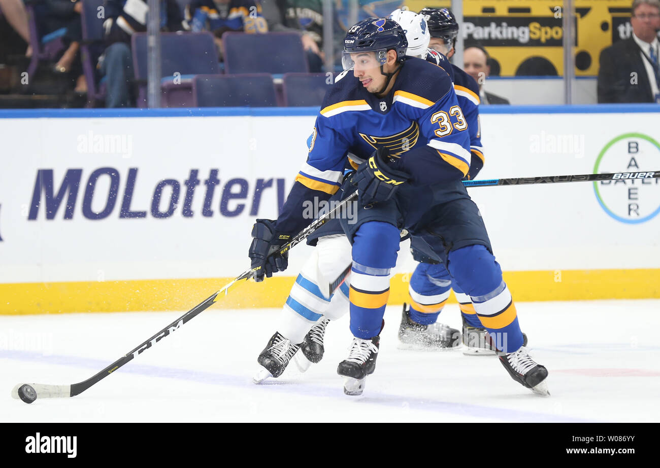 St. Louis Blues Jordan Kyrou tries to control the puck on his stick in ...