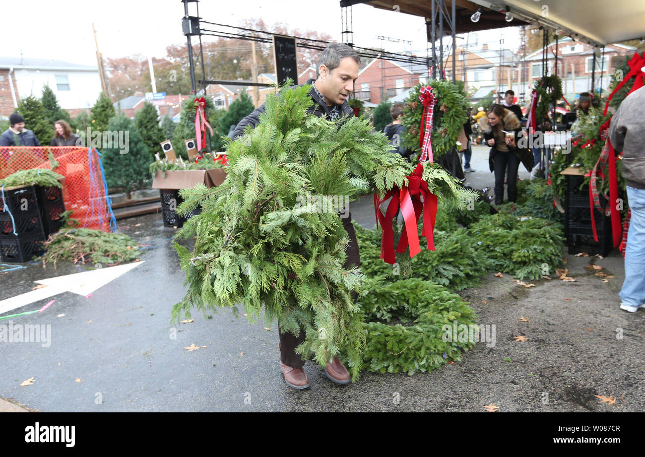 A customer carries a armful of garland leaving the Ted Drewe's ...