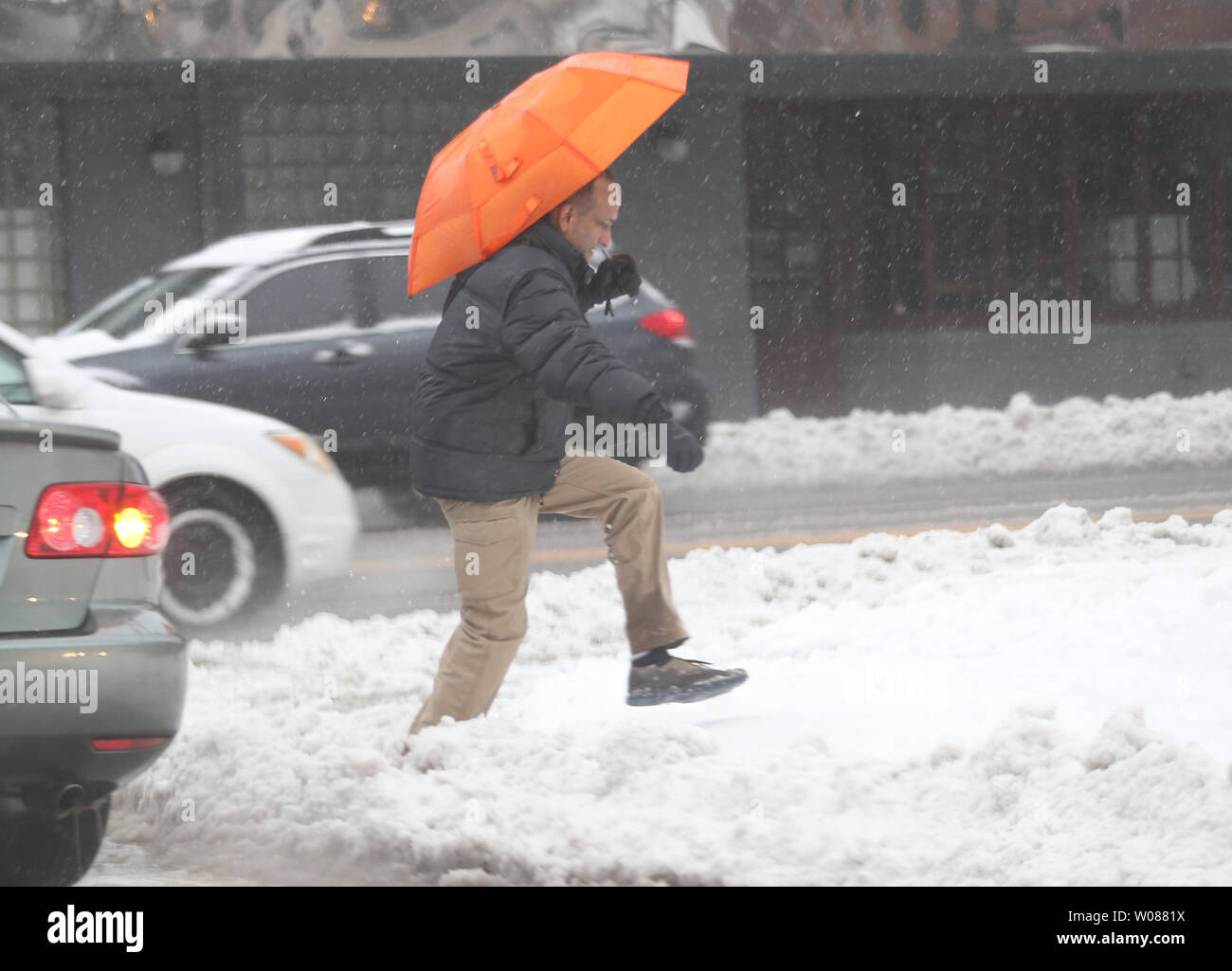 A man tries to find the sidewalk after crossing a downtown street as ...