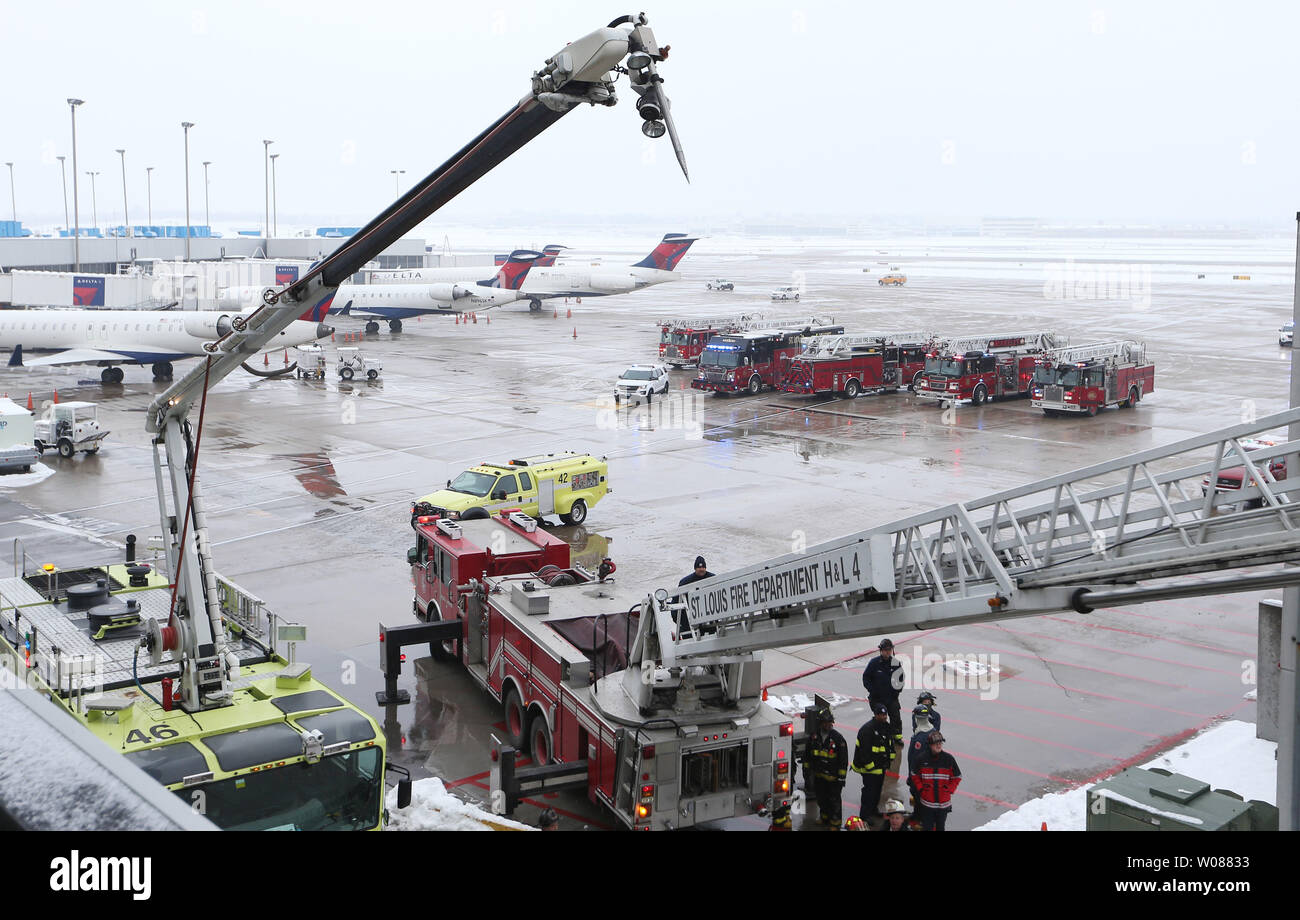 Fire trucks share the tarmac with airplanes at Terminal 1 at St. Louis ...