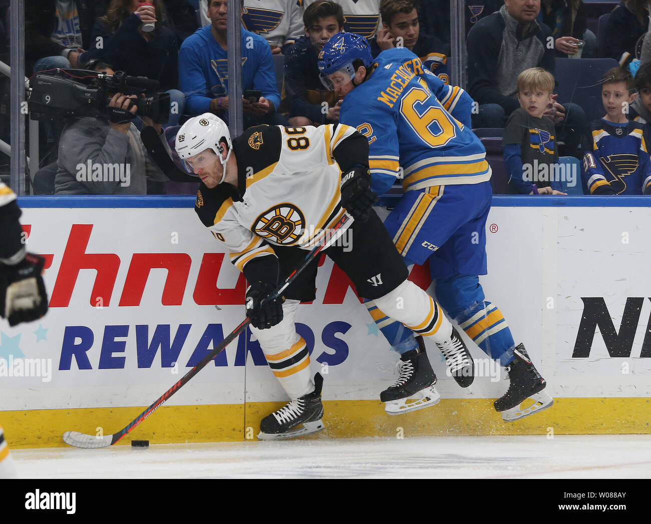 St. Louis Blues Mackenzie MacEachern pressures Boston Bruins Kevan ...
