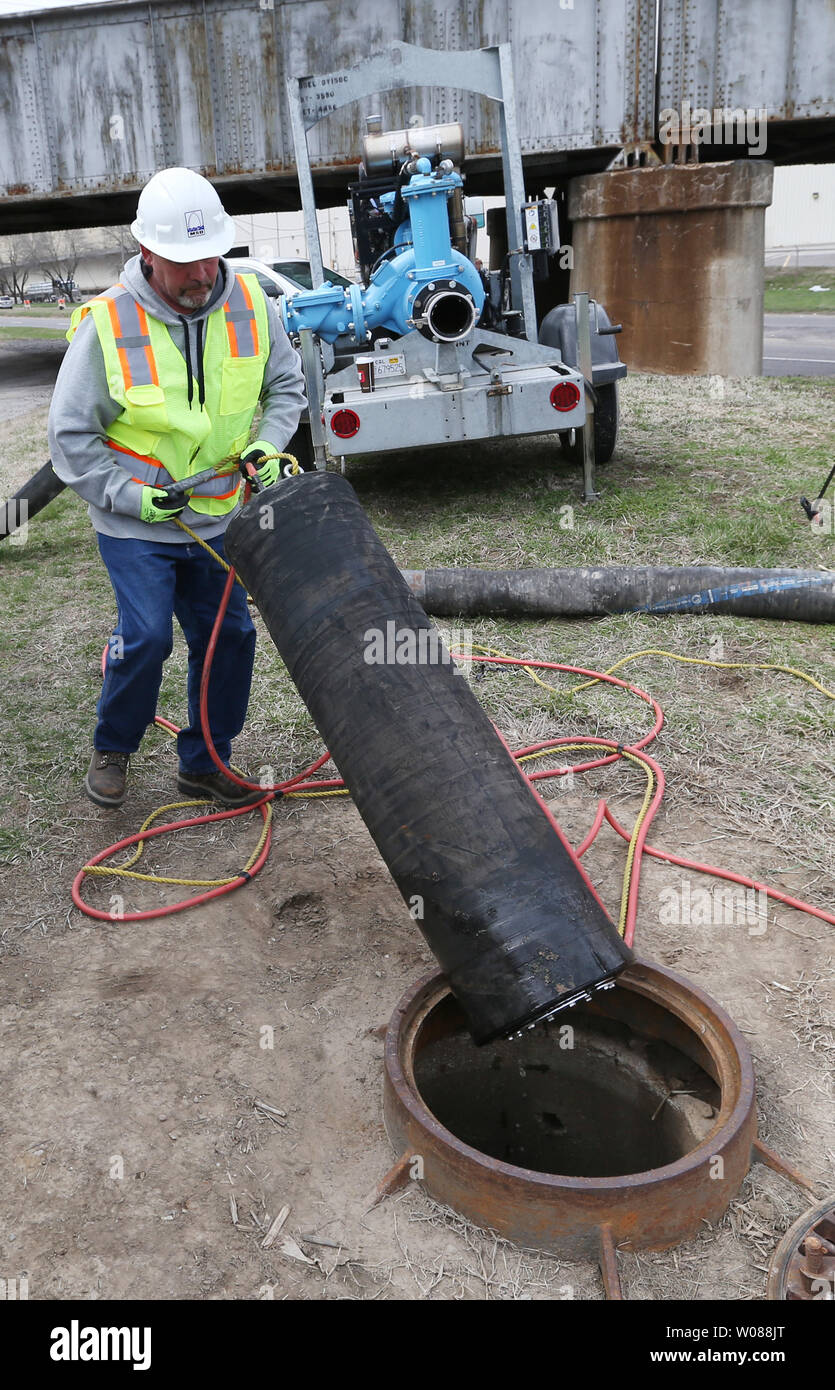 A Metropolitian Sewer District employee pulls a large plug from sewer ...