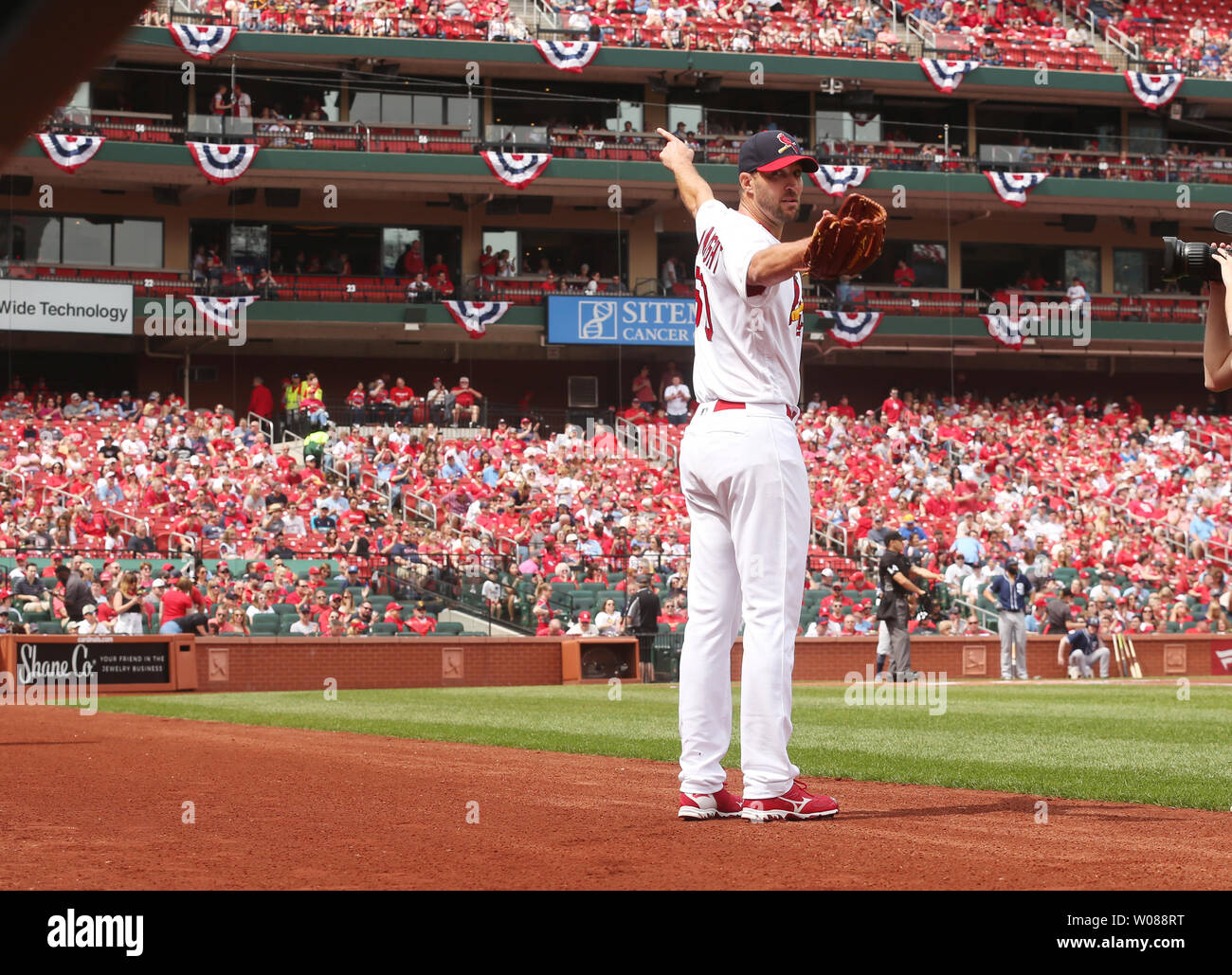 St. Louis Cardinals starting pitcher Adam Wainwright looks to make sure ...