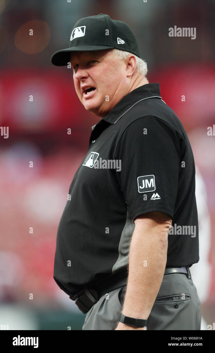 First base umpire Bill Miller looks to the St. Louis Cardinals dugout ...