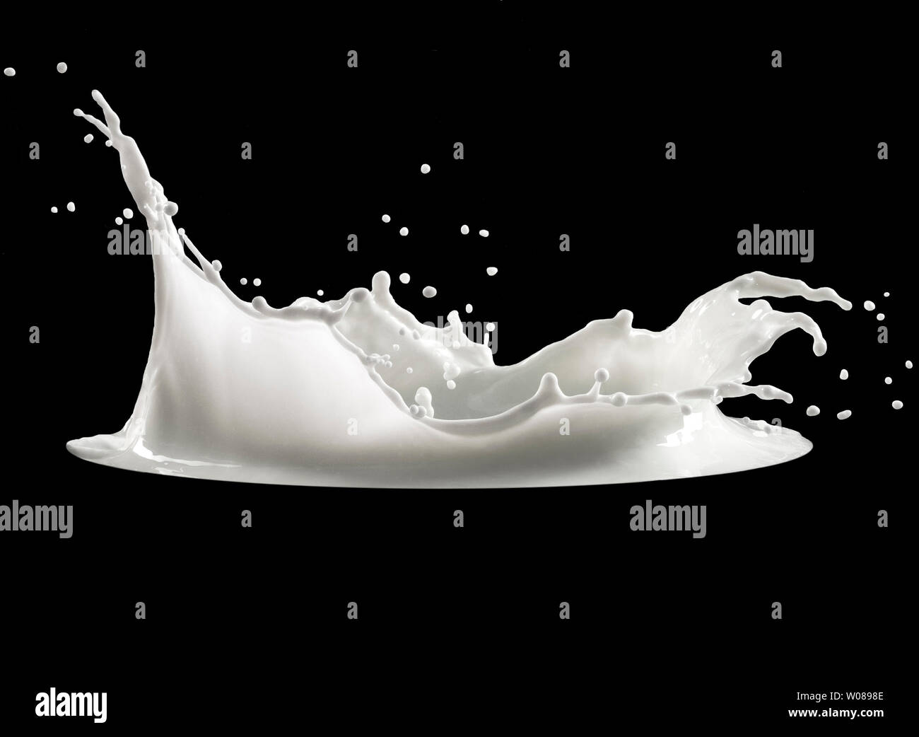 milk splash isolated on black background Stock Photo - Alamy
