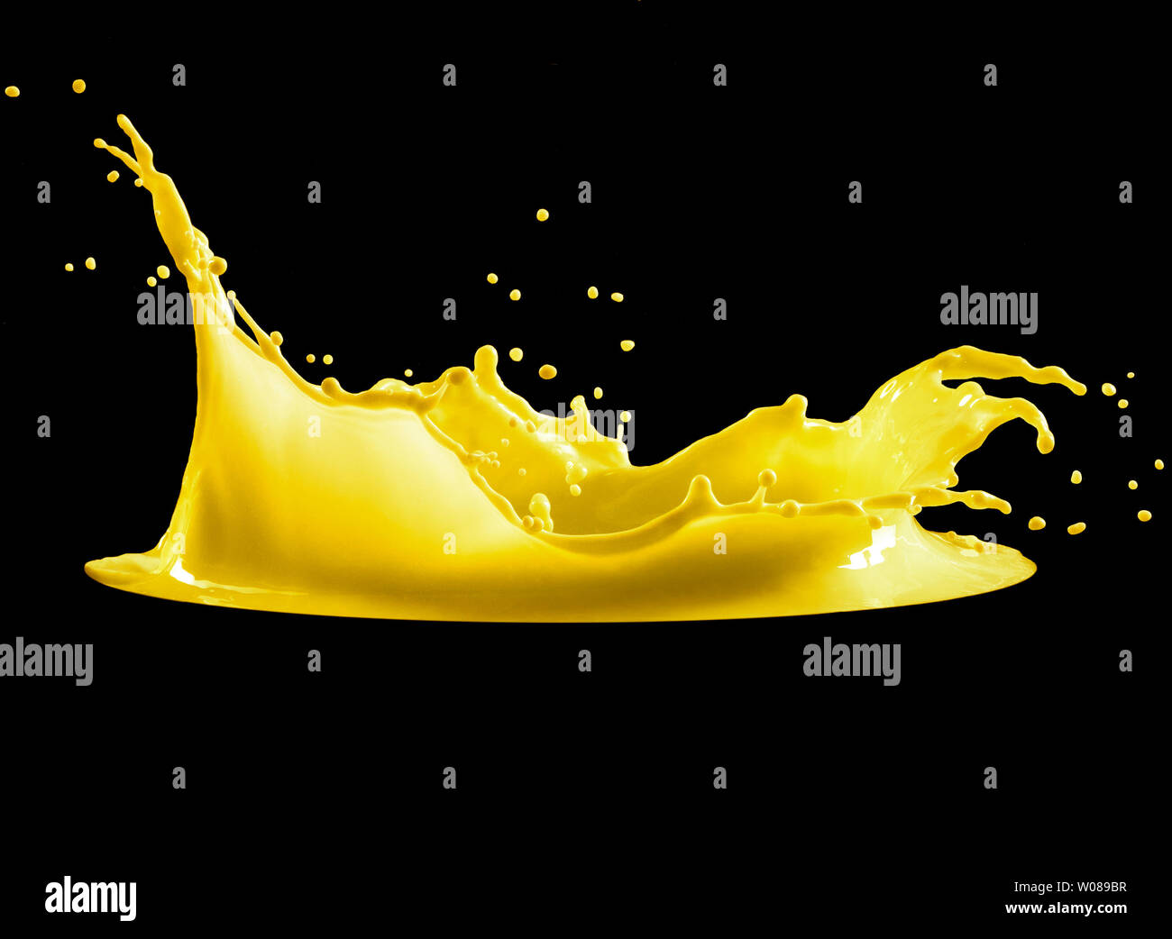 yellow paint splash isolated on black background Stock Photo - Alamy