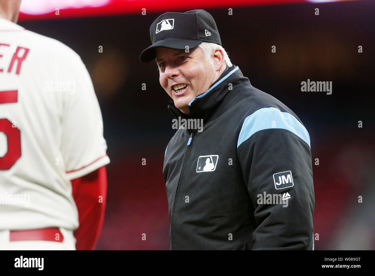 Major League umpire Tim Timmons jokes with St. Louis Cardinals third ...