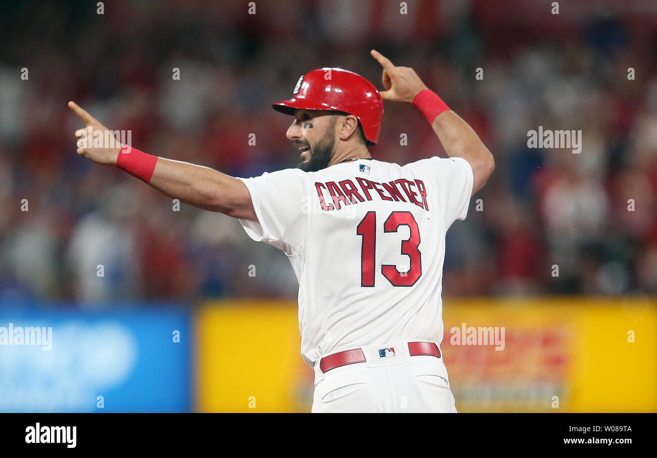 St. Louis Cardinals Matt Carpenter raises his arms, rounding first base ...