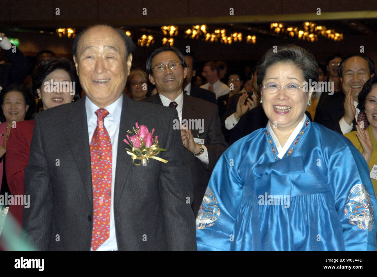 Rev. and Mrs. Sun Myung Moon greet guests at a banquet to celebrate ...