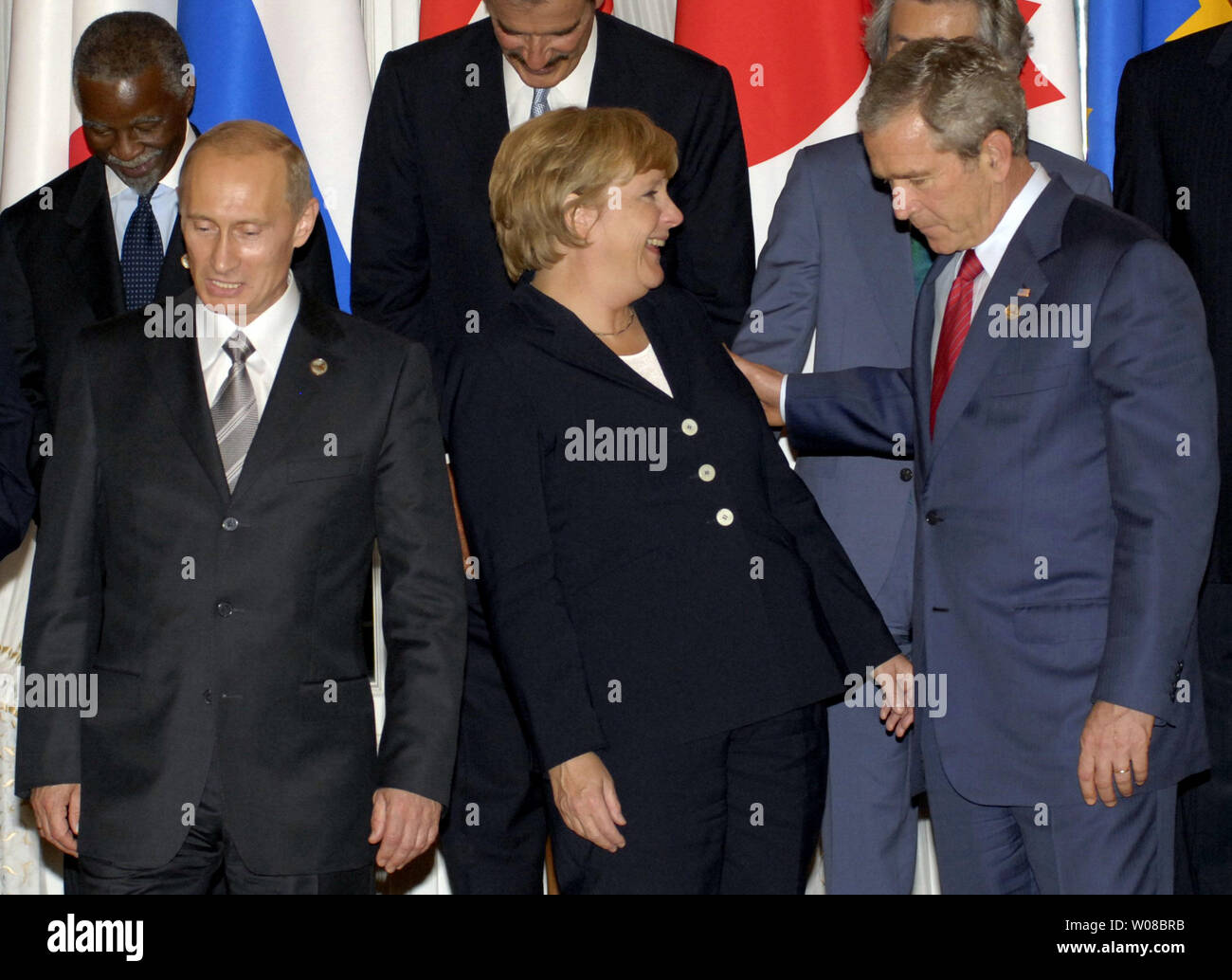 Russian President Vladimir Putin (L) looks down as German Chancellor ...