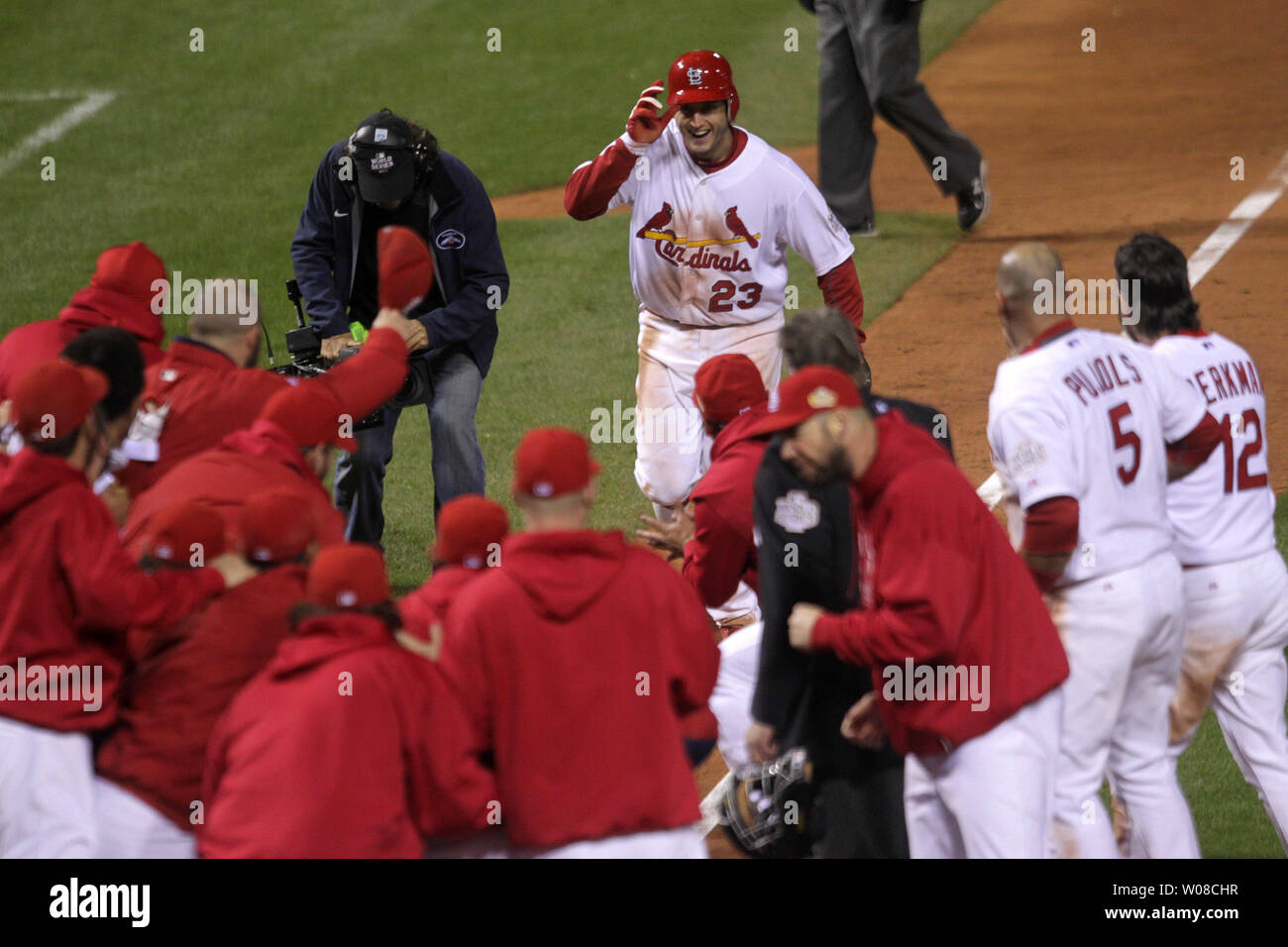 St. Louis Cardinals David Freese celebrates with his teammates at home ...