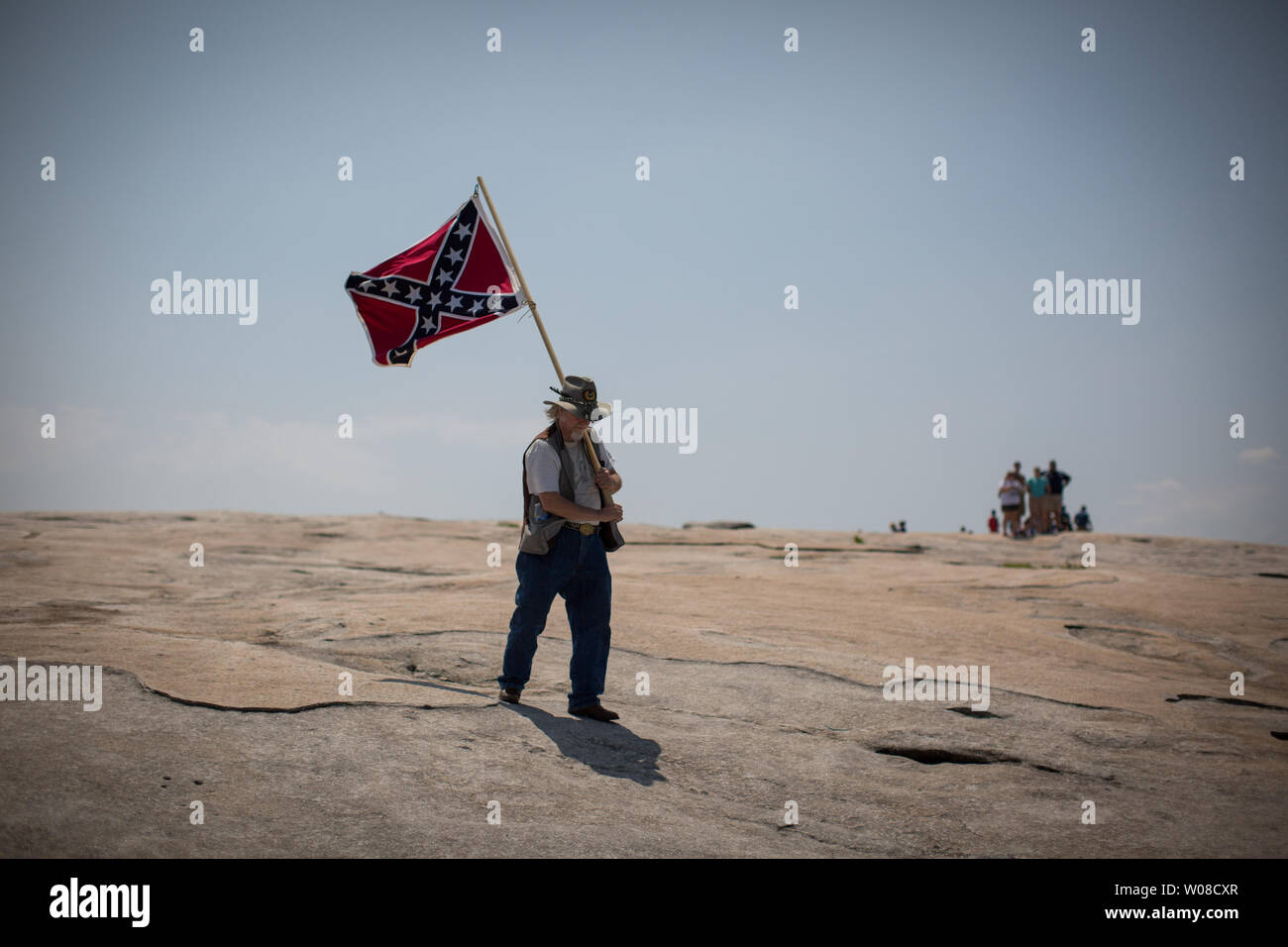 Steven Monk walks with a Confederate battle flag atop Stone Mountain ...