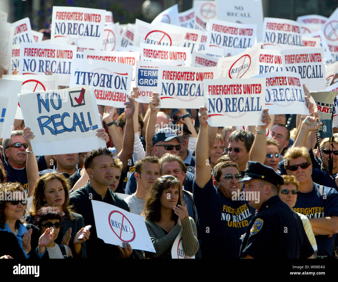 California Governor Gray Davisis cheered by firefighters at an anti ...