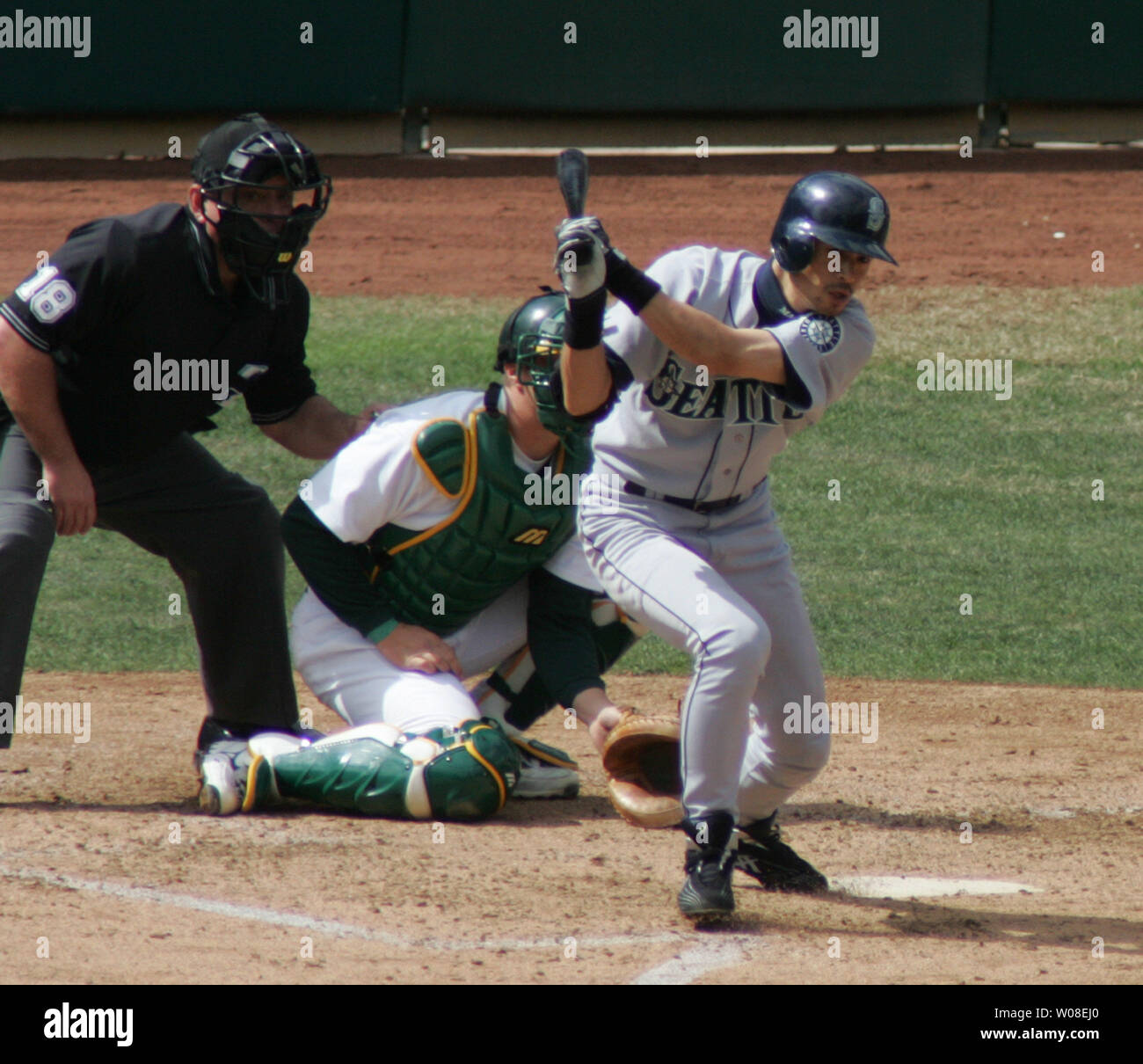 Seattle Mariners Ichiro Suzuki rips a hit off Oakland A's pitcher Mark ...