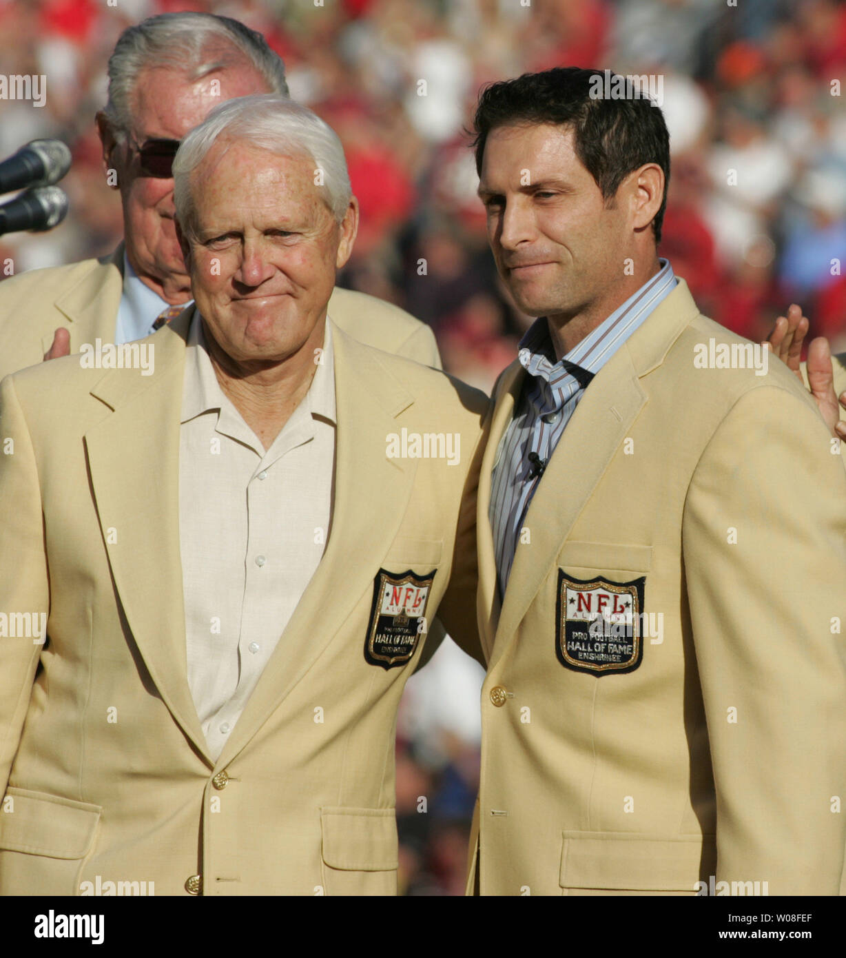 Hall of Fame QB Steve Young (R )stands with coach Bill Walsh, a fellow ...