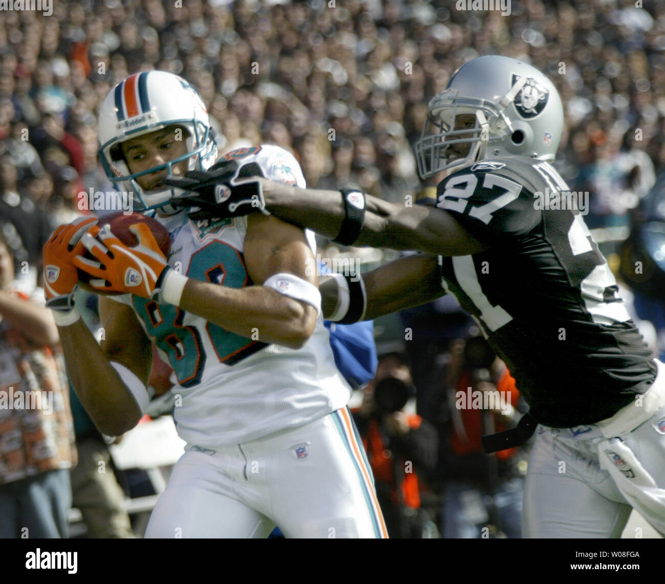 Miami Dolphins WR Bryan Gilmore (82) pulls in a Gus Frerotte pass for a ...