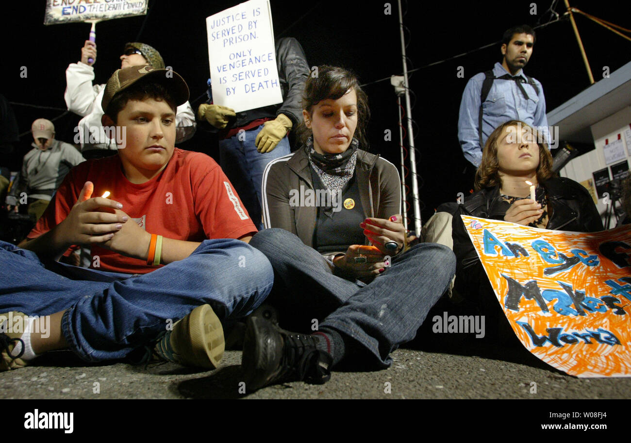 Jake Matheny (L), Nicole Salois (C) and Nelson Ackermann hold a vigil ...