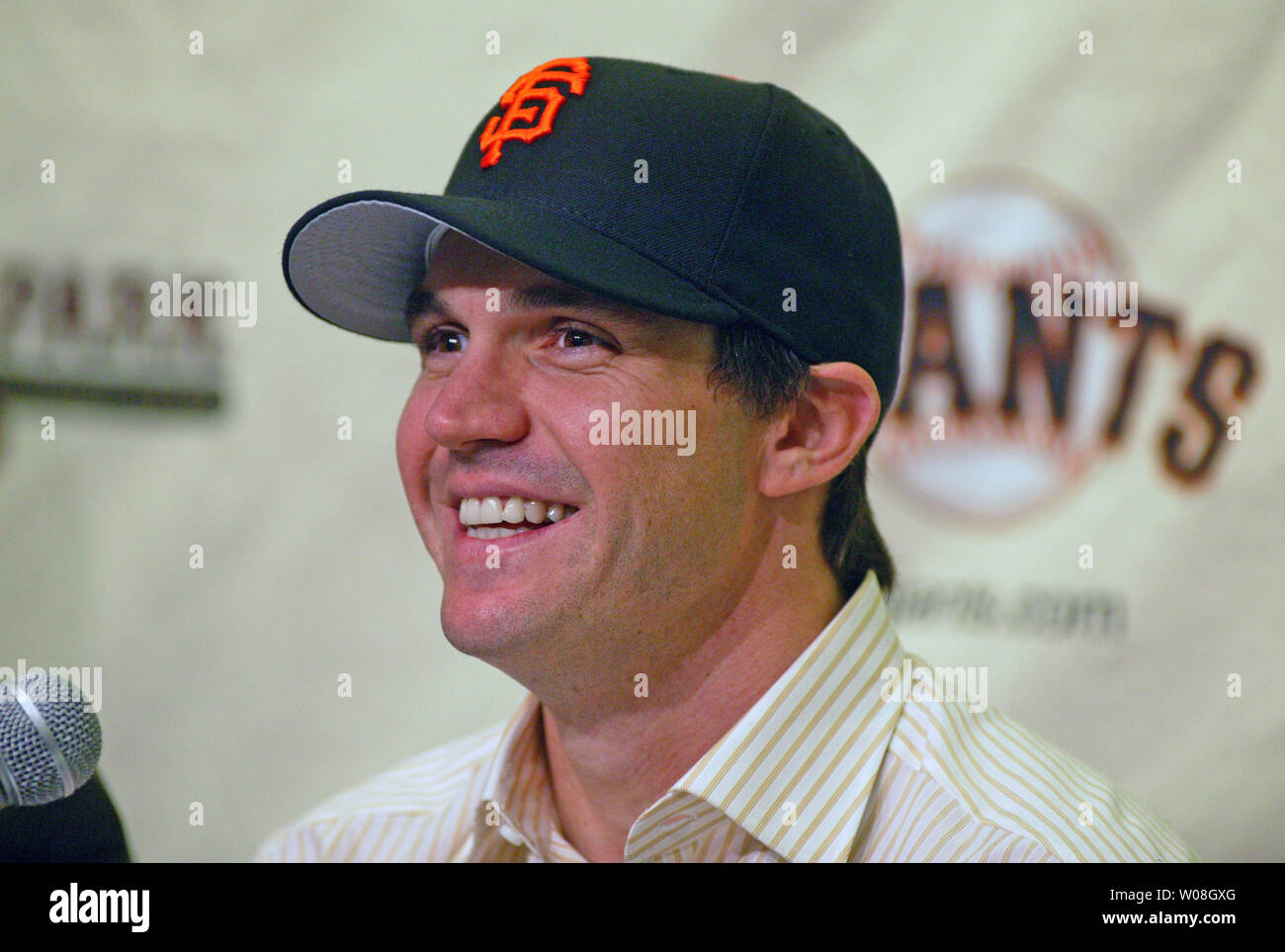 Barry Zito smiles with his new San Francisco Giants cap at a press ...