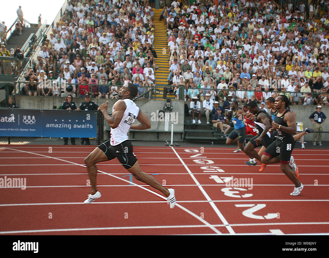 U.S. sprinter Tyson Gay blows past the pack at the finish line in the ...