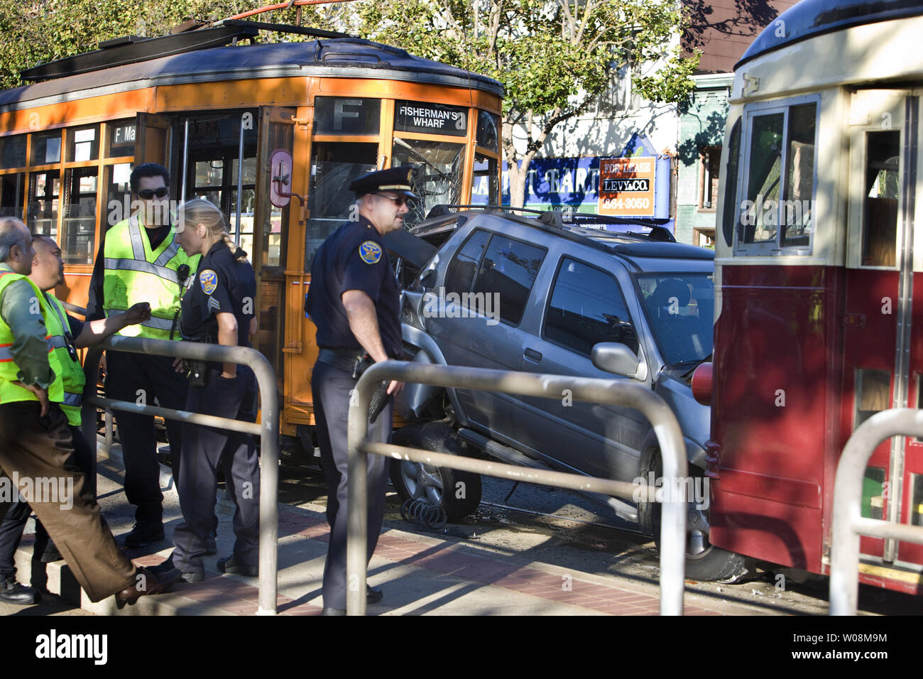 Police and Municipal Railway officials confer as a Nissan Pathfinder ...