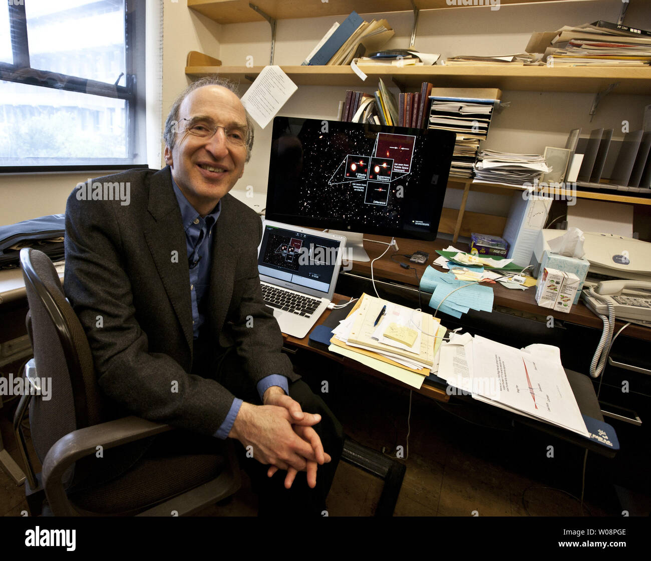Saul Perlmutter, winner of the 2011 Nobel Prize in physics, sits at his ...