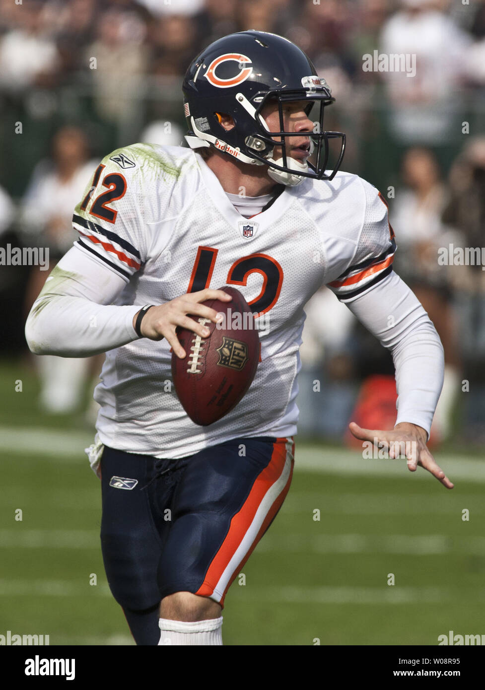 Chicago Bears QB Caleb Hanie (12) scrambles away from the Oakland ...