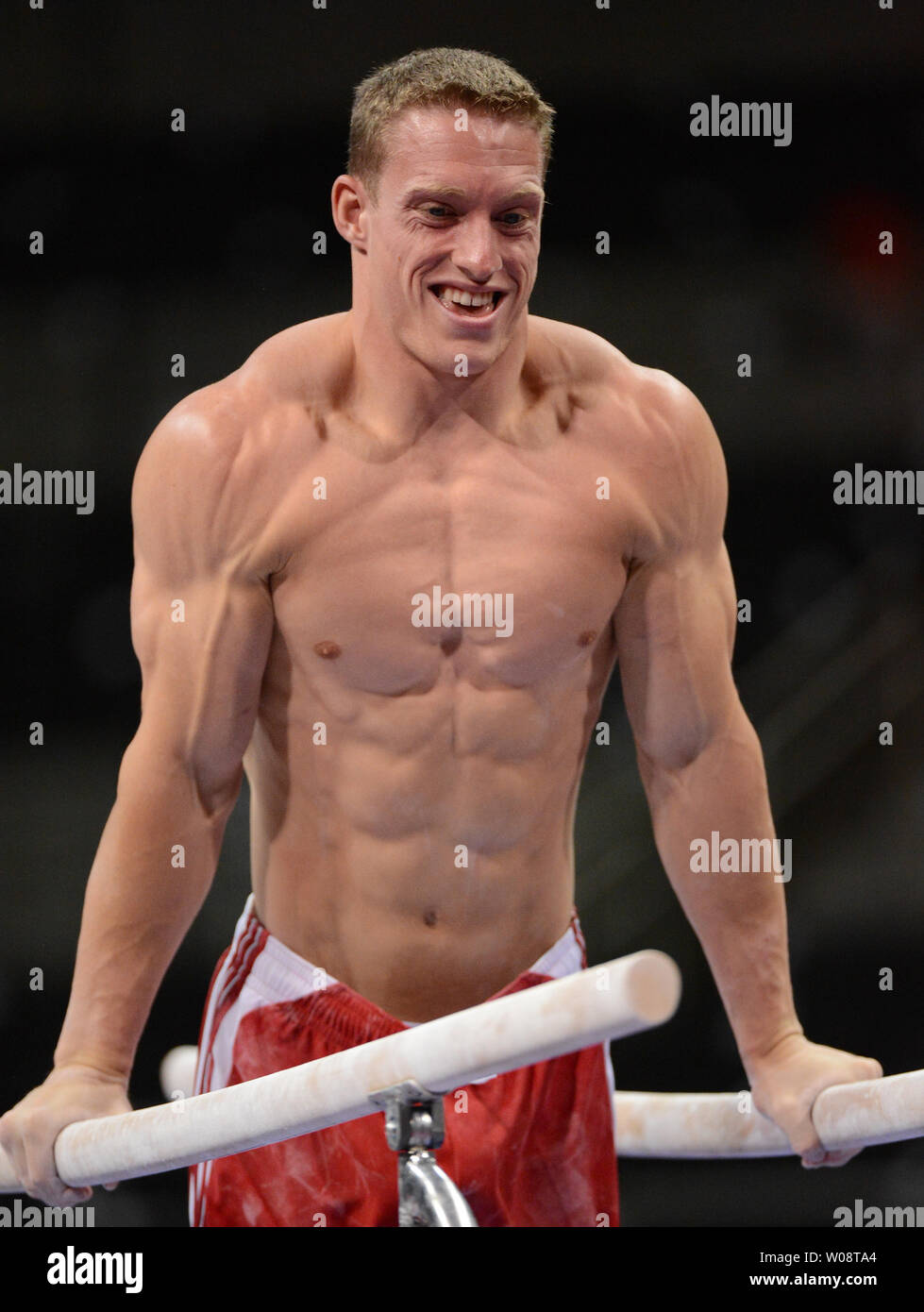 Steven Legendre warms up on the parallel bars at the US Olympic trials ...