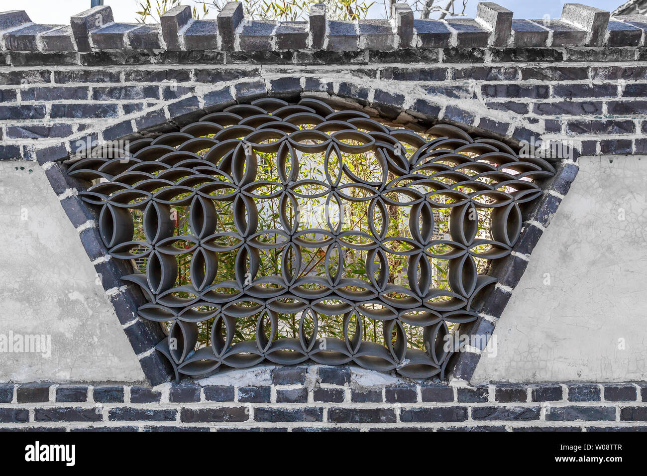 Garden wall tile hollowed-out window Stock Photo - Alamy