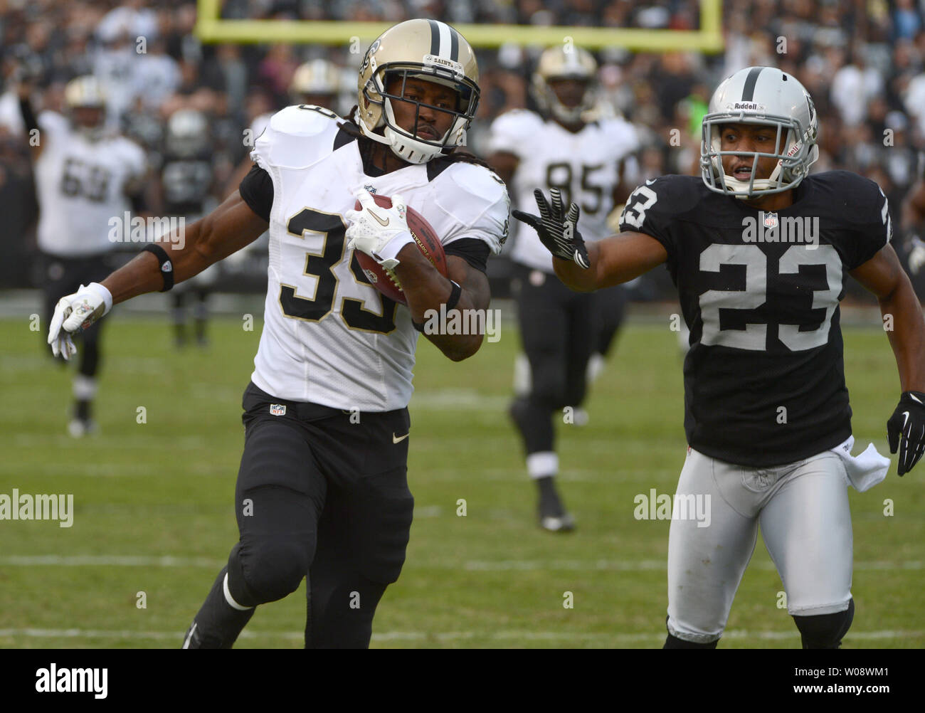 New Orleans Saints RB Travaris Cadet (39) is pushed by Oakland Raiders ...