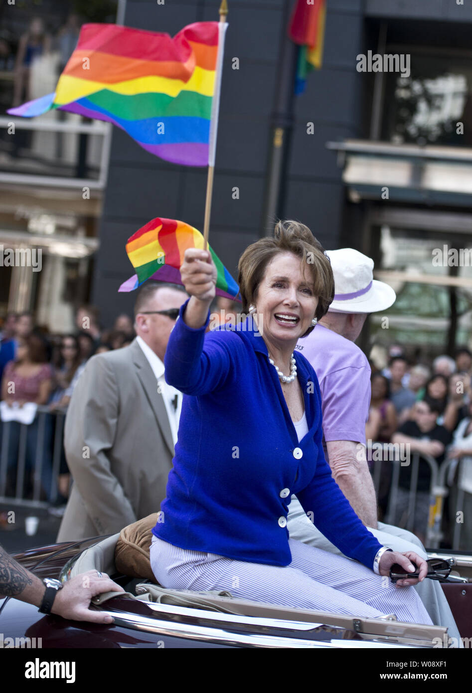 Rep. Nancy Pelosi (D-CA) waves a flag in the annual LGBT Pride Parade ...