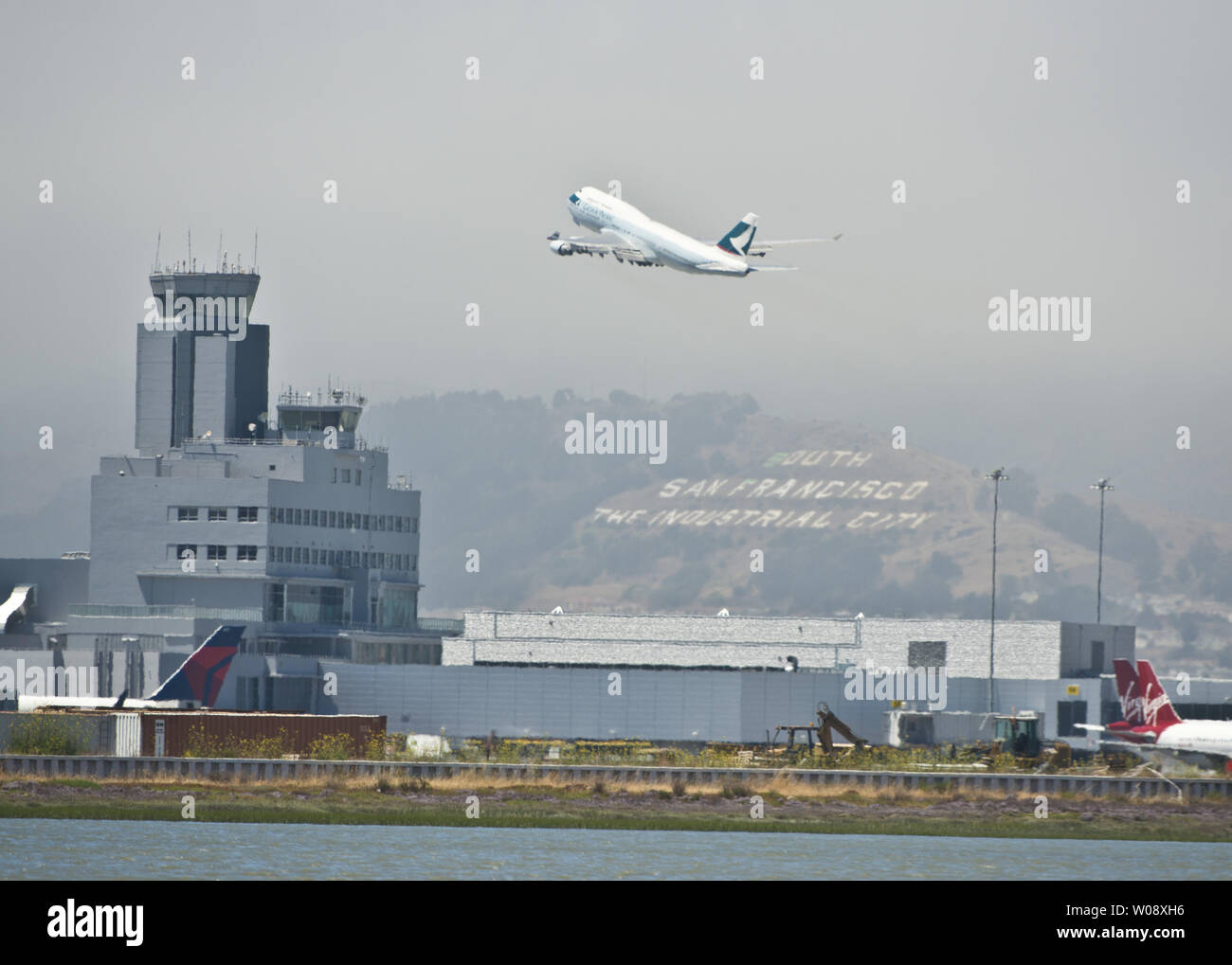 A Cathy Pacific plane takes off at San Francisco International Airport ...