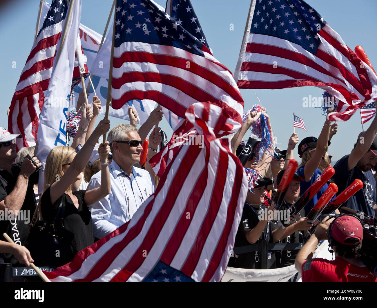 Oracle Team USA fans wave flags at the dock out ceremony before the ...