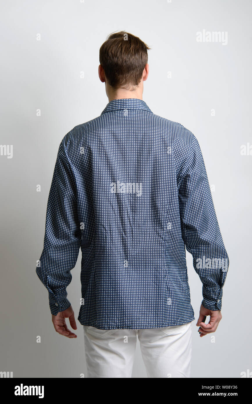 A Brown hair Caucasian male model poses in vintage clothing outfit, back facing camera, a men's ...