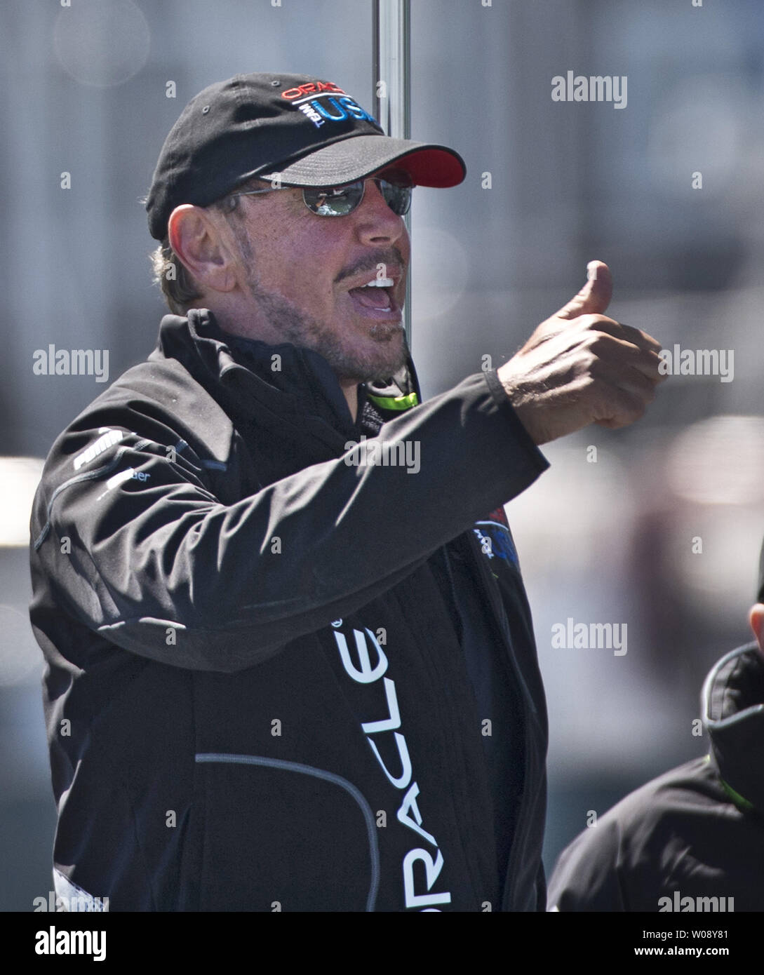Oracle CEO Larry Ellison gives a thumbs up to his team after they ...