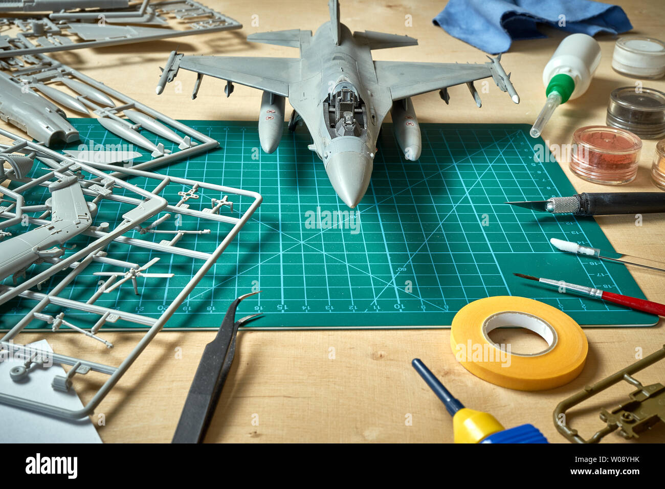 Top view on plastic model scale with accessories on green pad on wooden ...