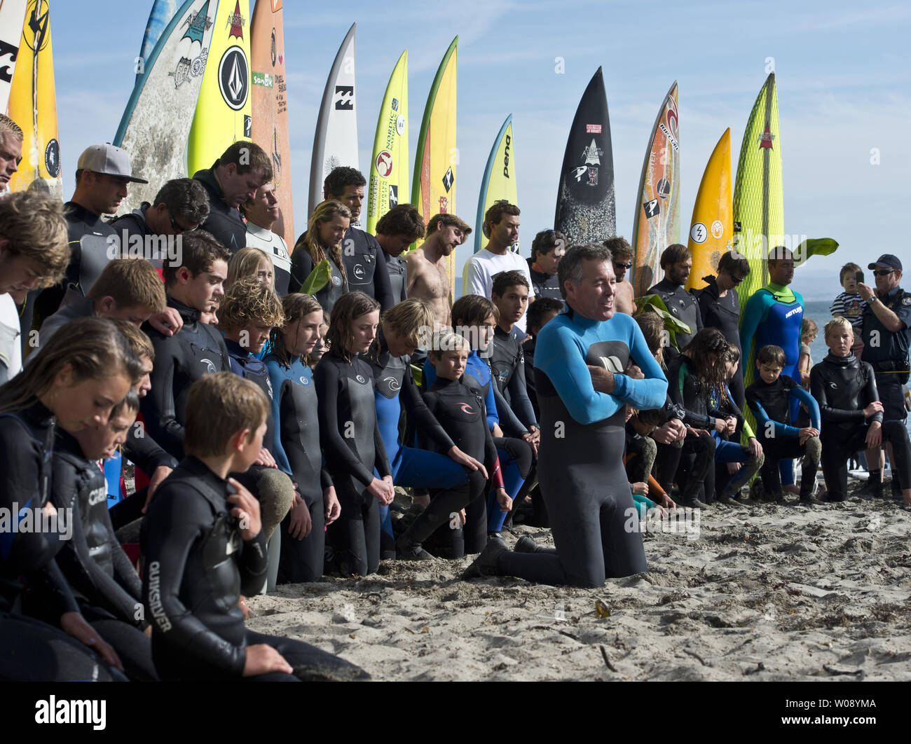 Mavericks Invitational contest director Jeff Clark (C) leads a prayer ...