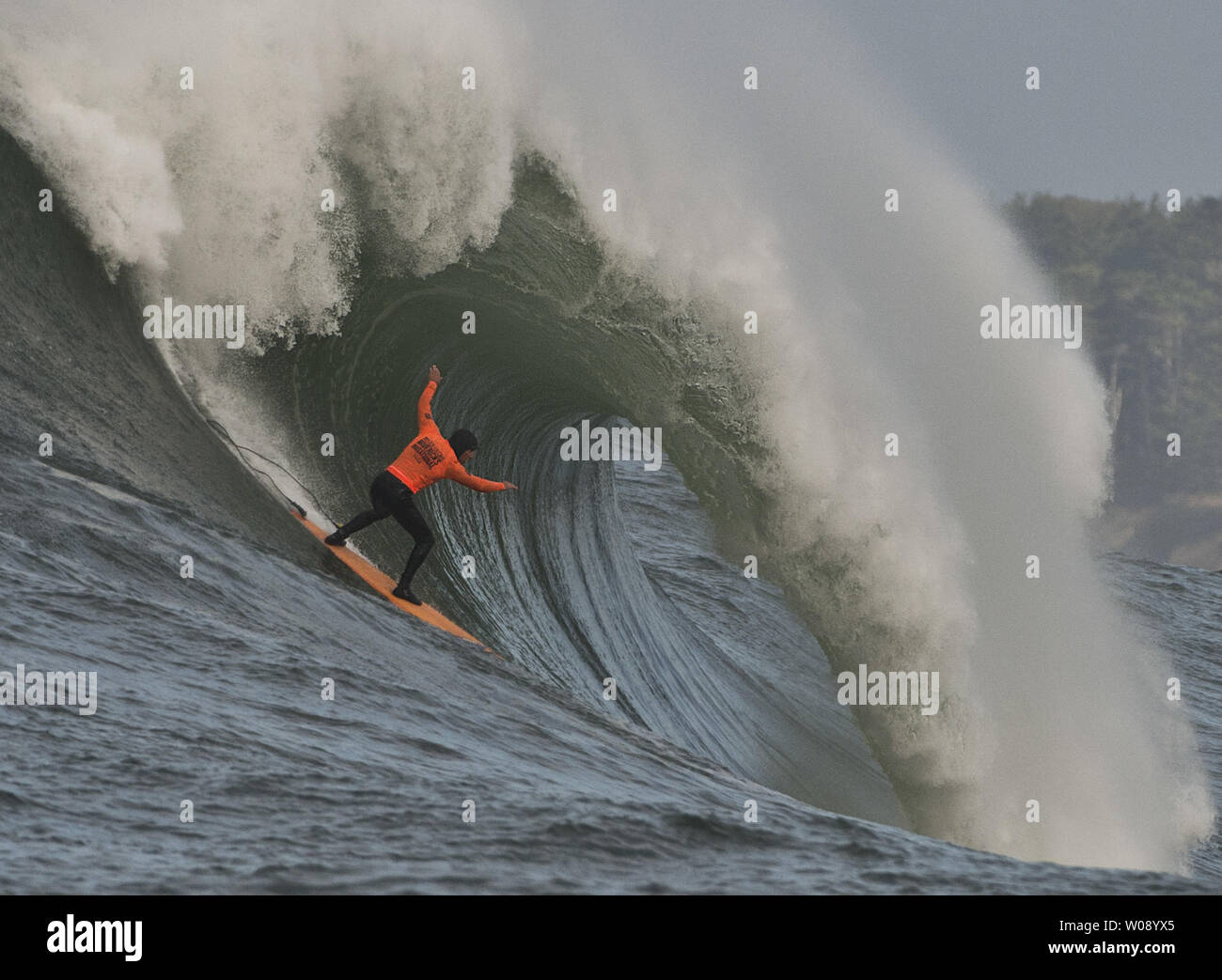 Ken Collins rides a wave in the first heat of the Mavericks ...