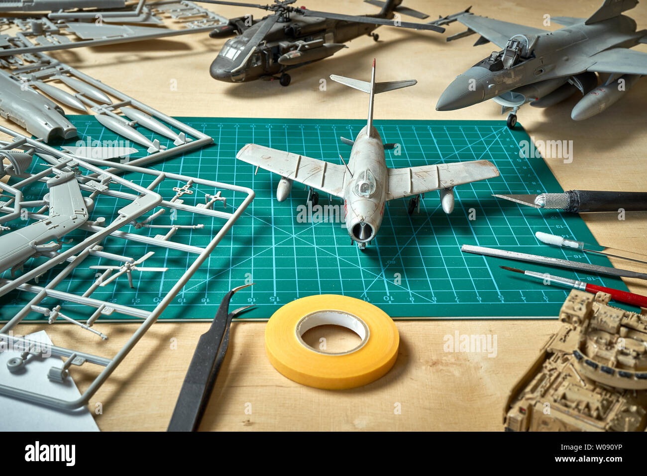 Top view on plastic model scale with accessories on green pad on wooden ...