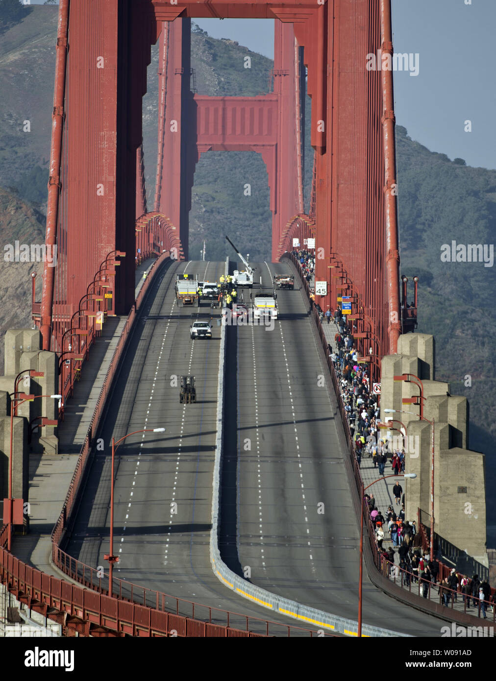 Workers install a movable median barrier on the Golden Gate Bridge in ...