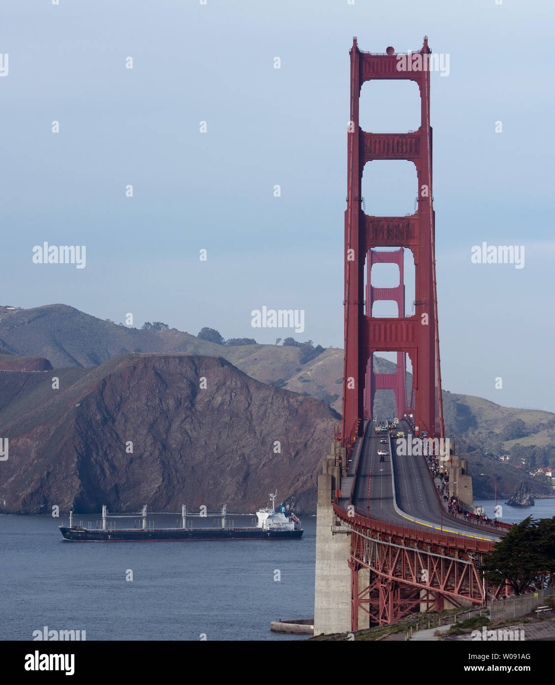 Workers install a movable median barrier on the Golden Gate Bridge in ...