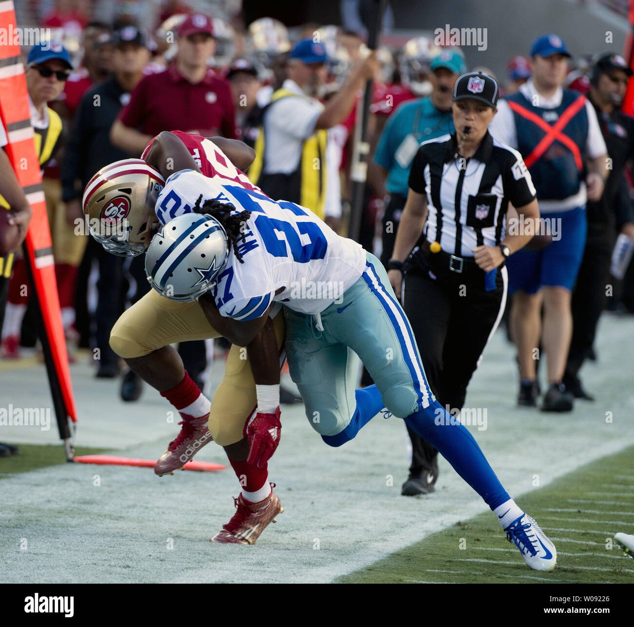 NFL Line Judge Catherine Conti (R) follows the action on the sidelines ...