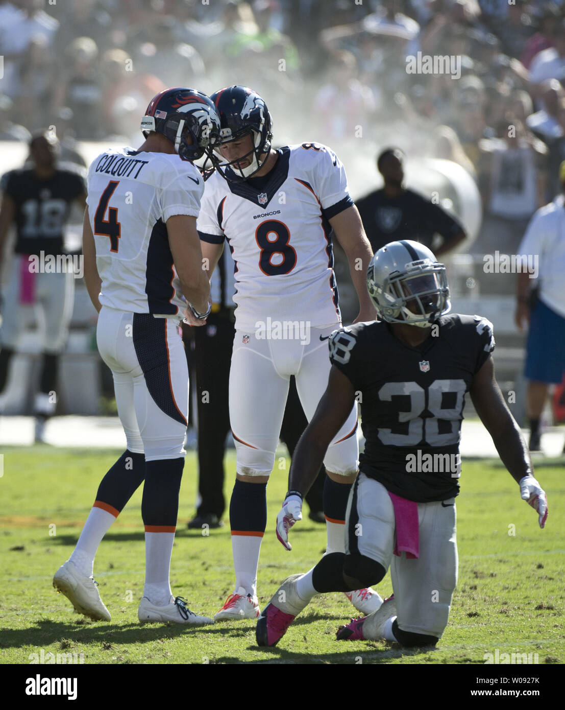 Denver Broncos kicker Brandon McManus (8) bumps heads with holder Britton Colquitt after kicking ...