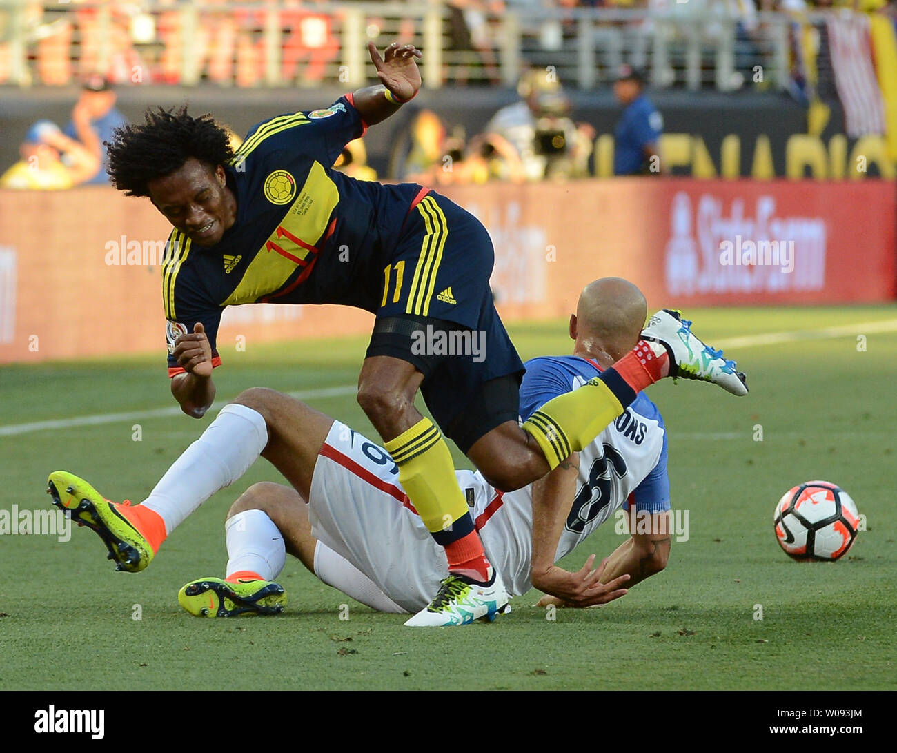 Columbia's Juan Cuadrado (11) is tripped up by USA's John Brooks (6) in ...