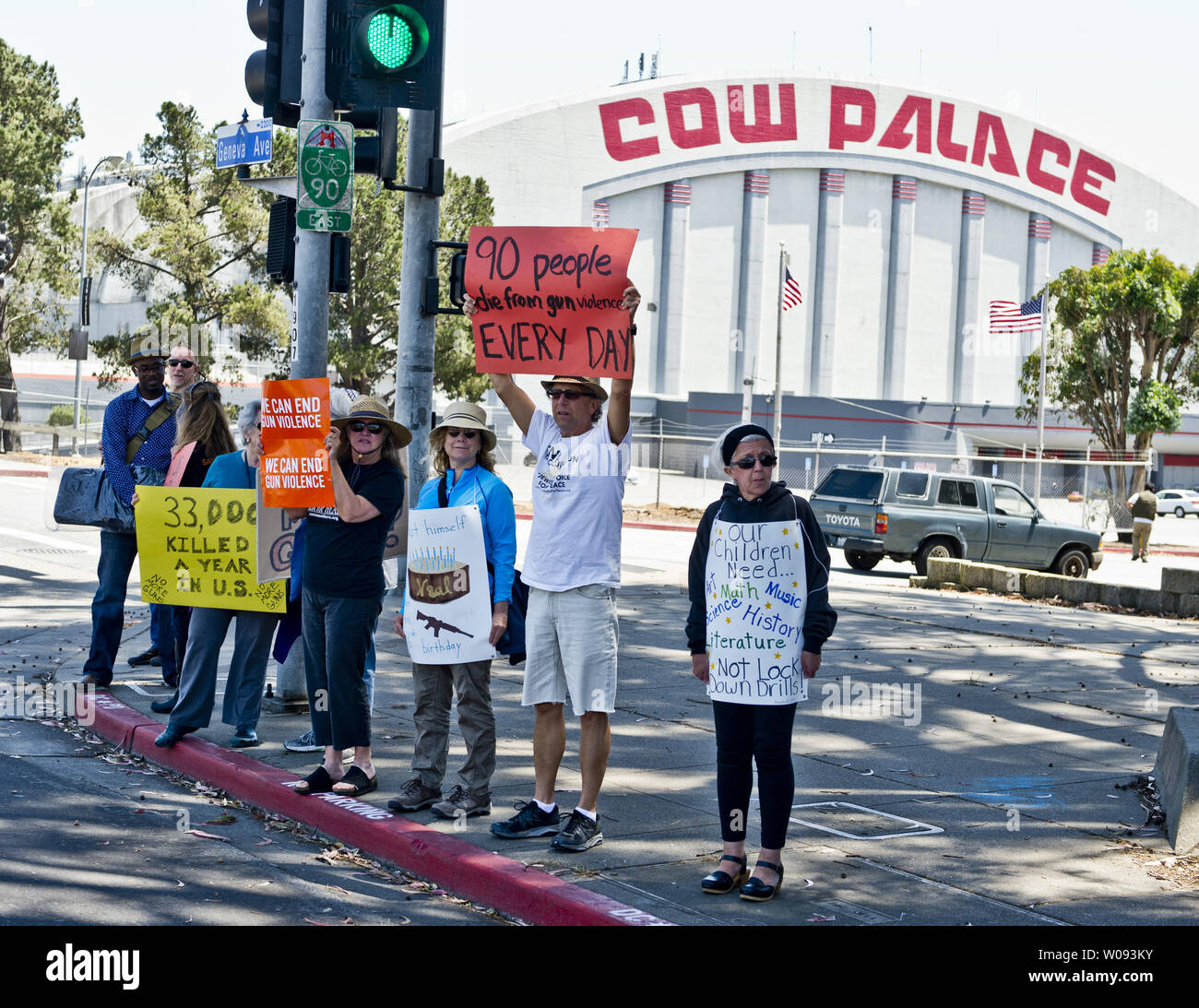 Anti-gun activists hold signs outside the the 'Crossroads of the West ...