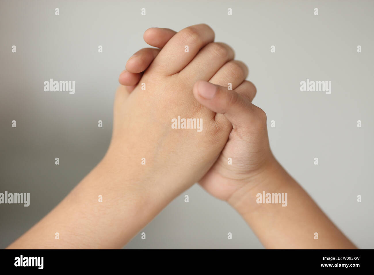 Close up of children hand arm wrestling Stock Photo - Alamy
