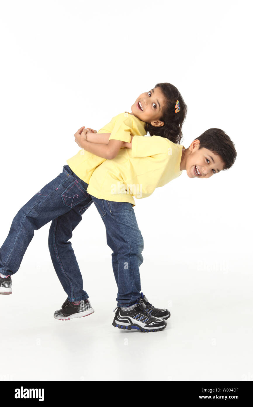 Boy carrying his friend back to back Stock Photo - Alamy